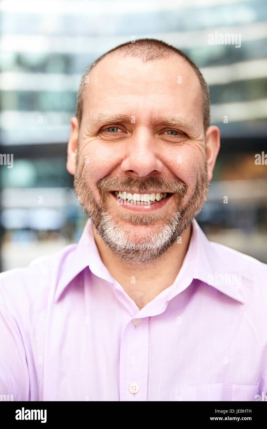 Smiling businessman standing in front of his office Stock Photo - Alamy