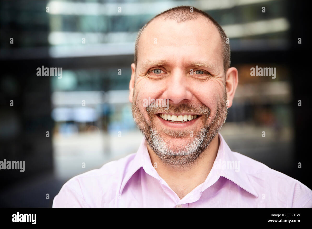 Successful man standing in front of his office Stock Photo - Alamy