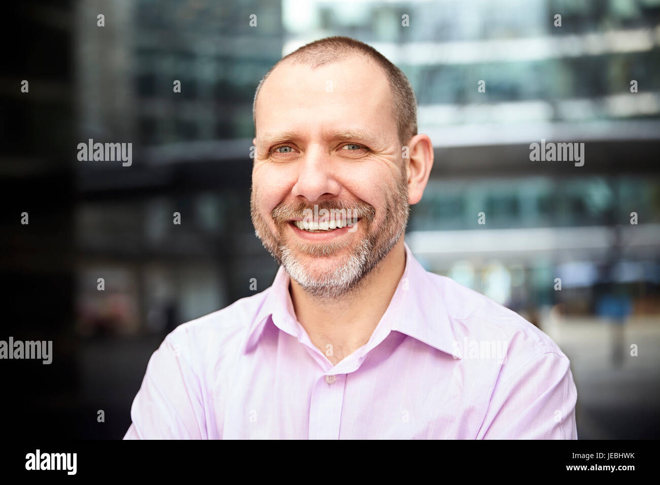 Successful businessman standing in front of his office Stock Photo - Alamy