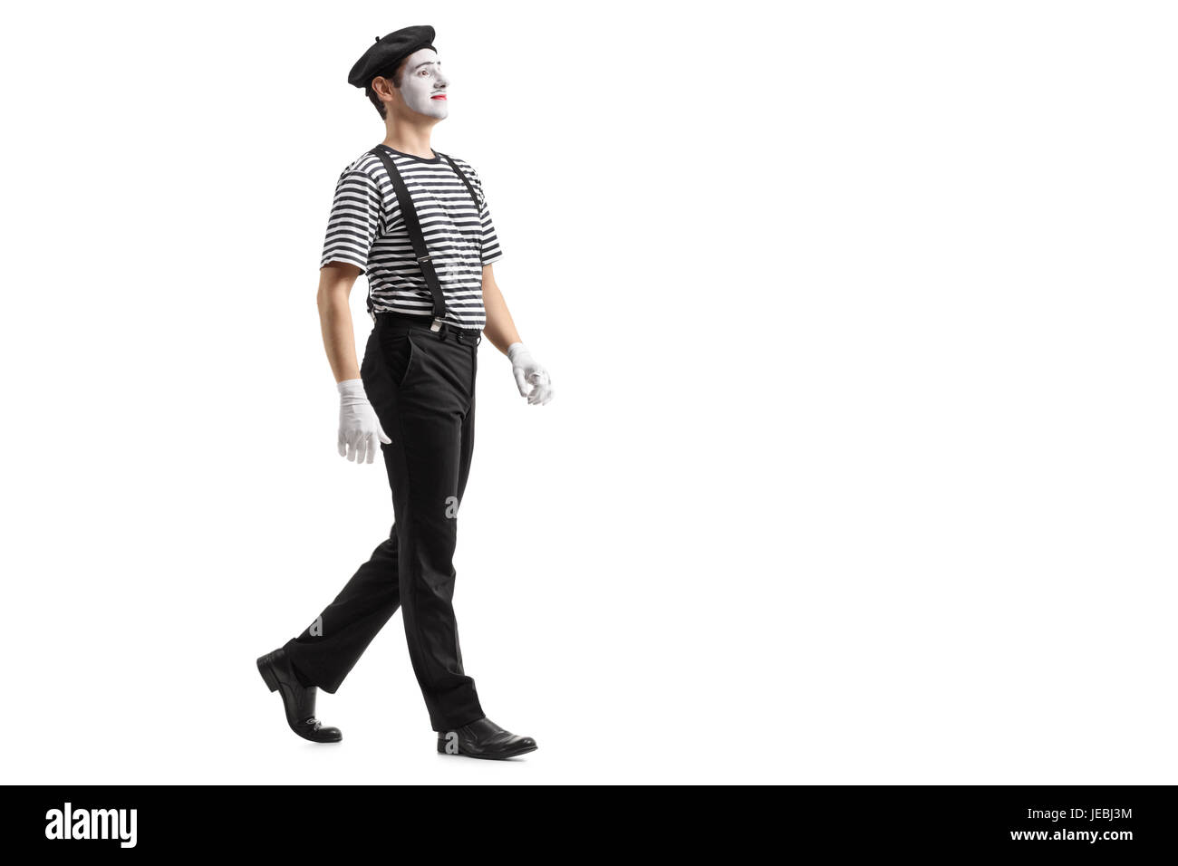 Full length profile shot of a mime walking isolated on white background ...