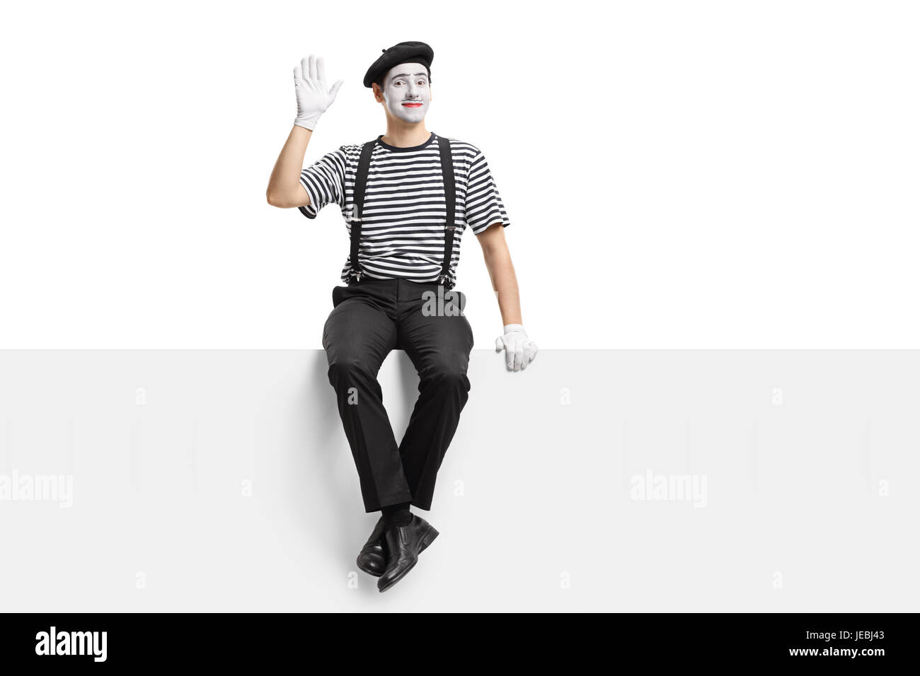 Mime artist sitting on a panel and waving at the camera isolated on ...