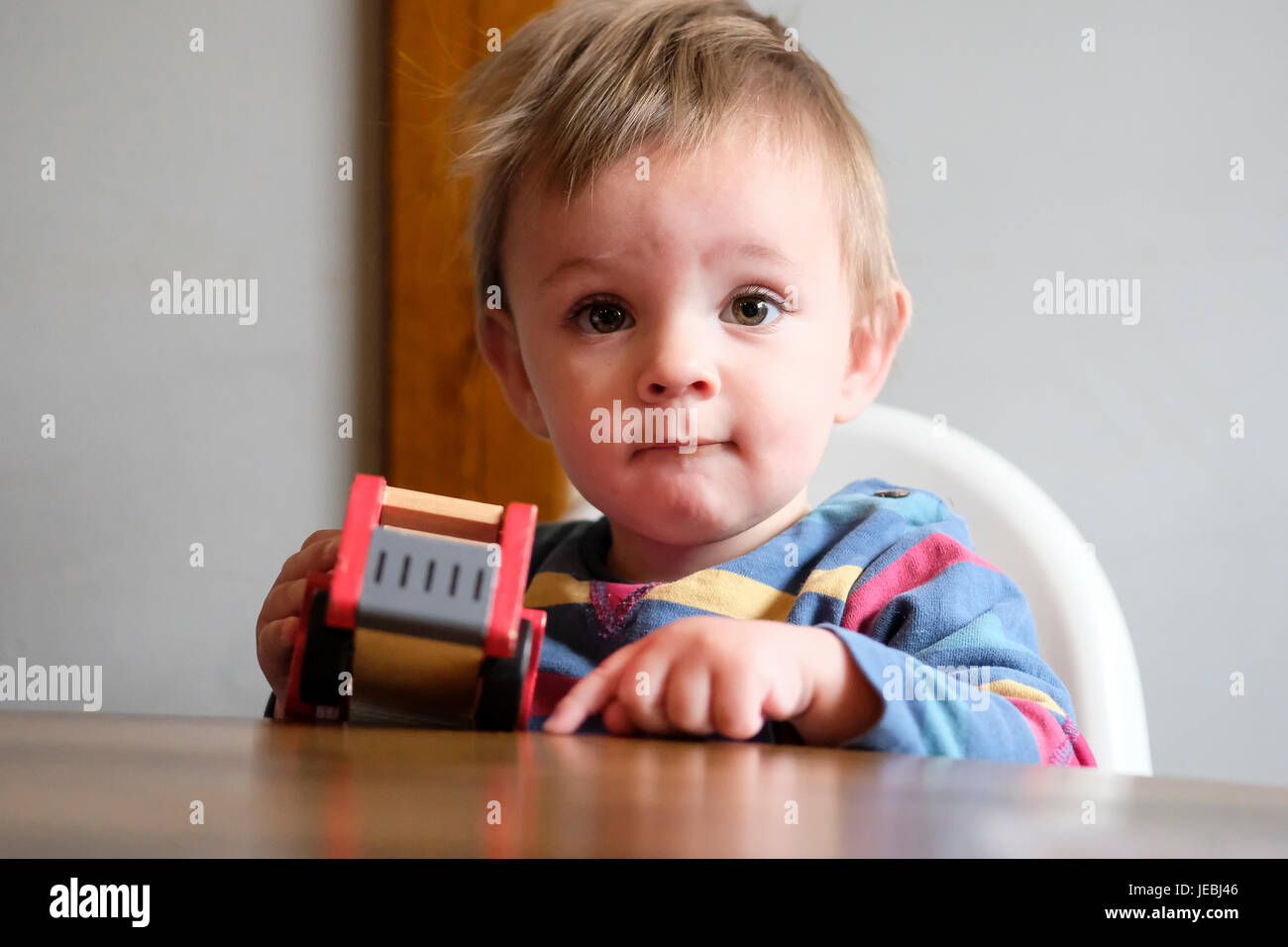 baby boy playing with wooden toy car Stock Photo - Alamy