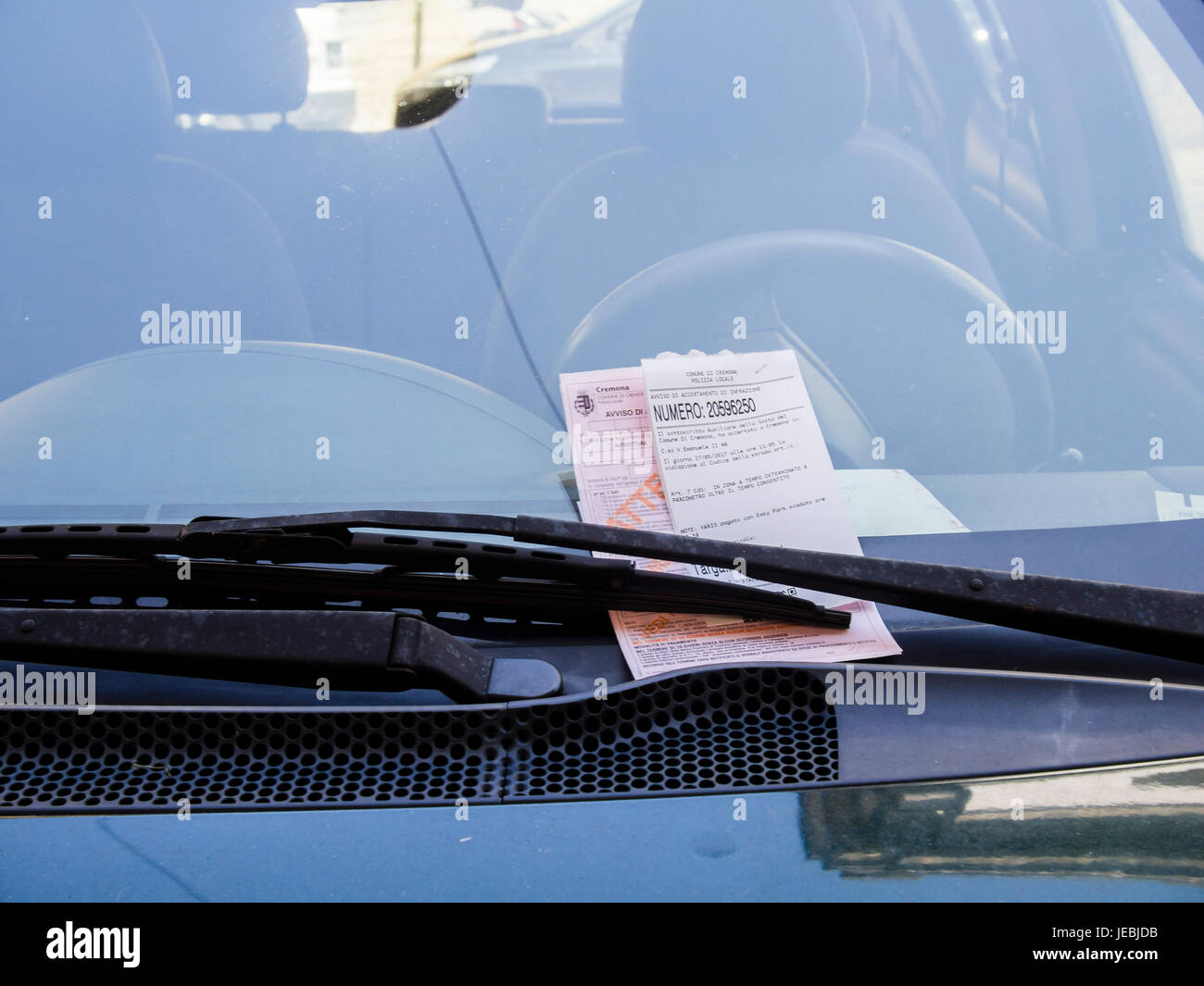 Street parking ticket left in a car windshield by a police officer ...