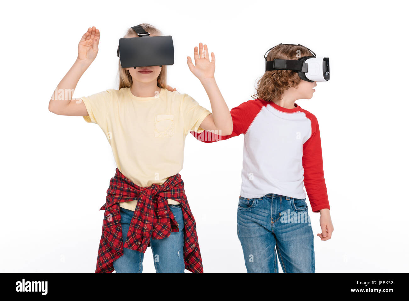 Boy and girl have fun while using virtual reality headsets isolated ...