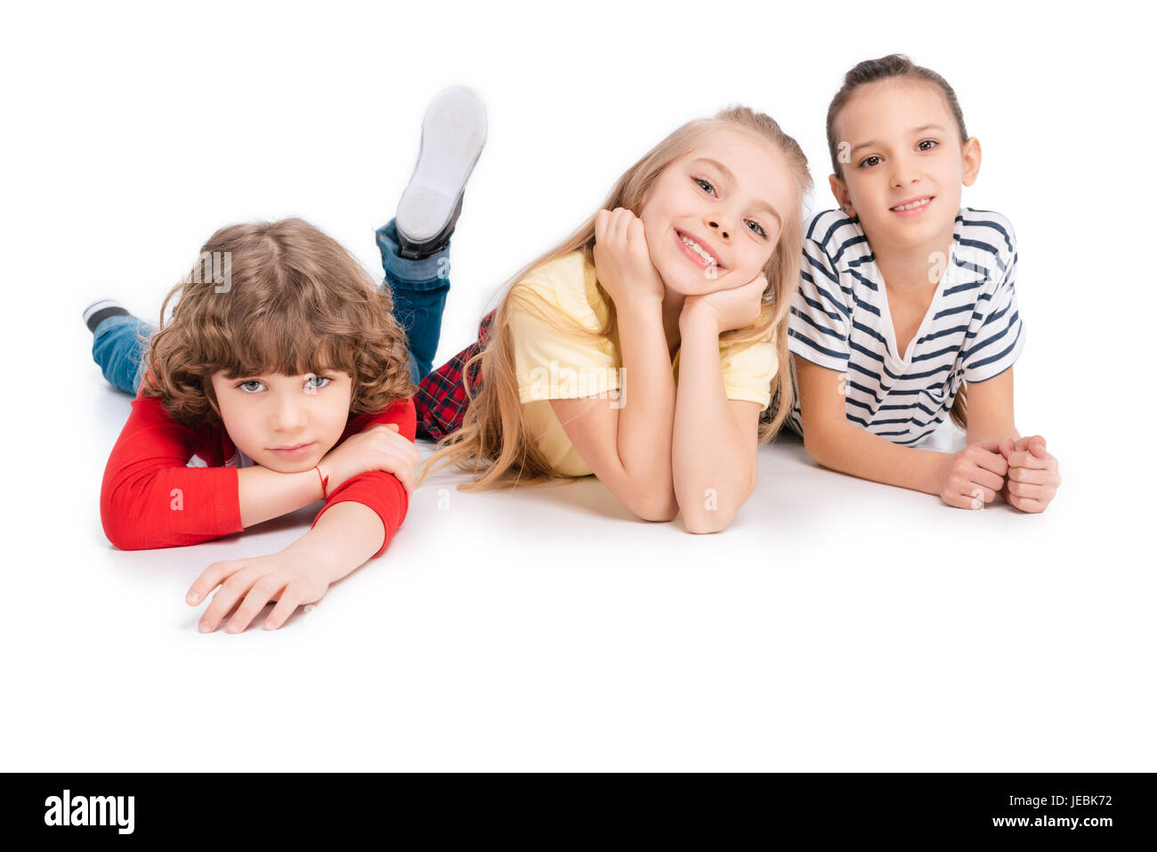 Cheerful kids lying on floor and have fun isolated on white Stock Photo ...