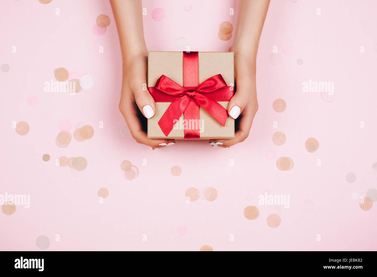 Hands holding present box Stock Photo - Alamy