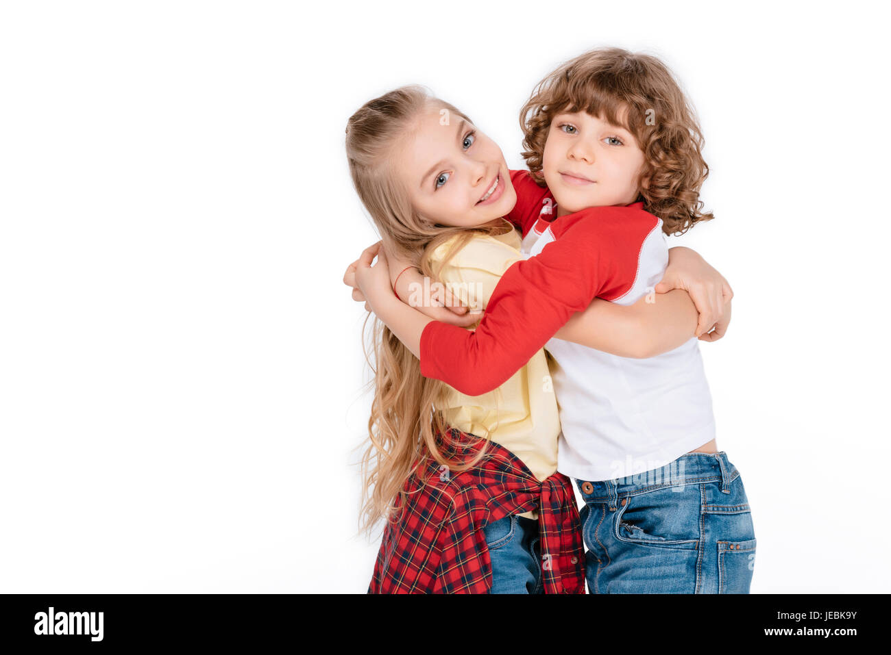 Young boy and girl embracing and have fun isolated on white Stock Photo ...