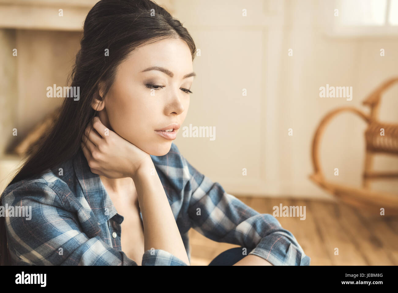 Portrait of young engrossed woman daydreaming with hand on chin Stock ...