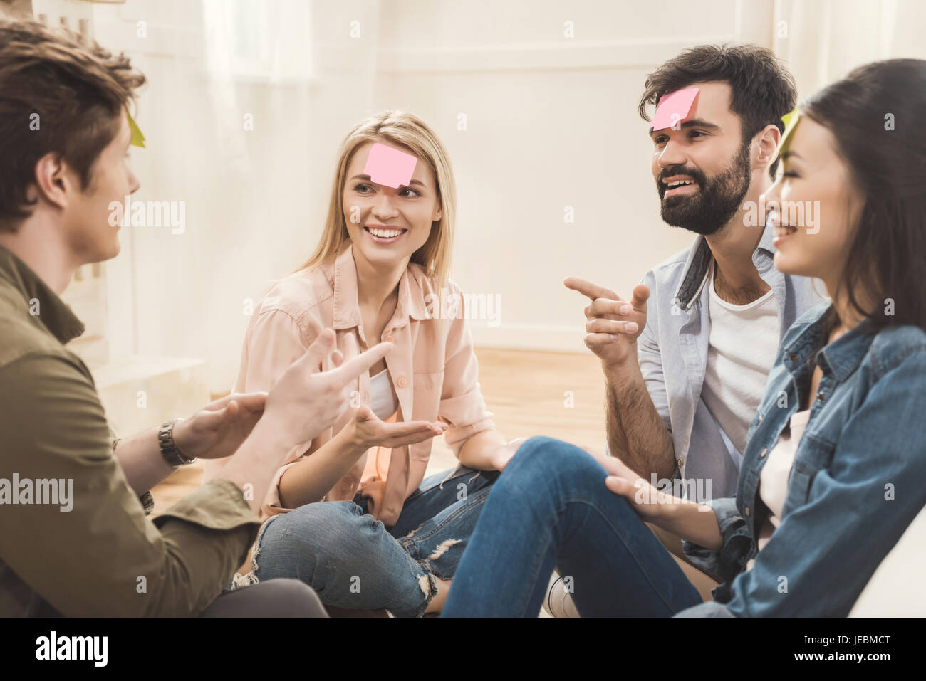 Diverse people playing game guess who and having fun at home Stock ...
