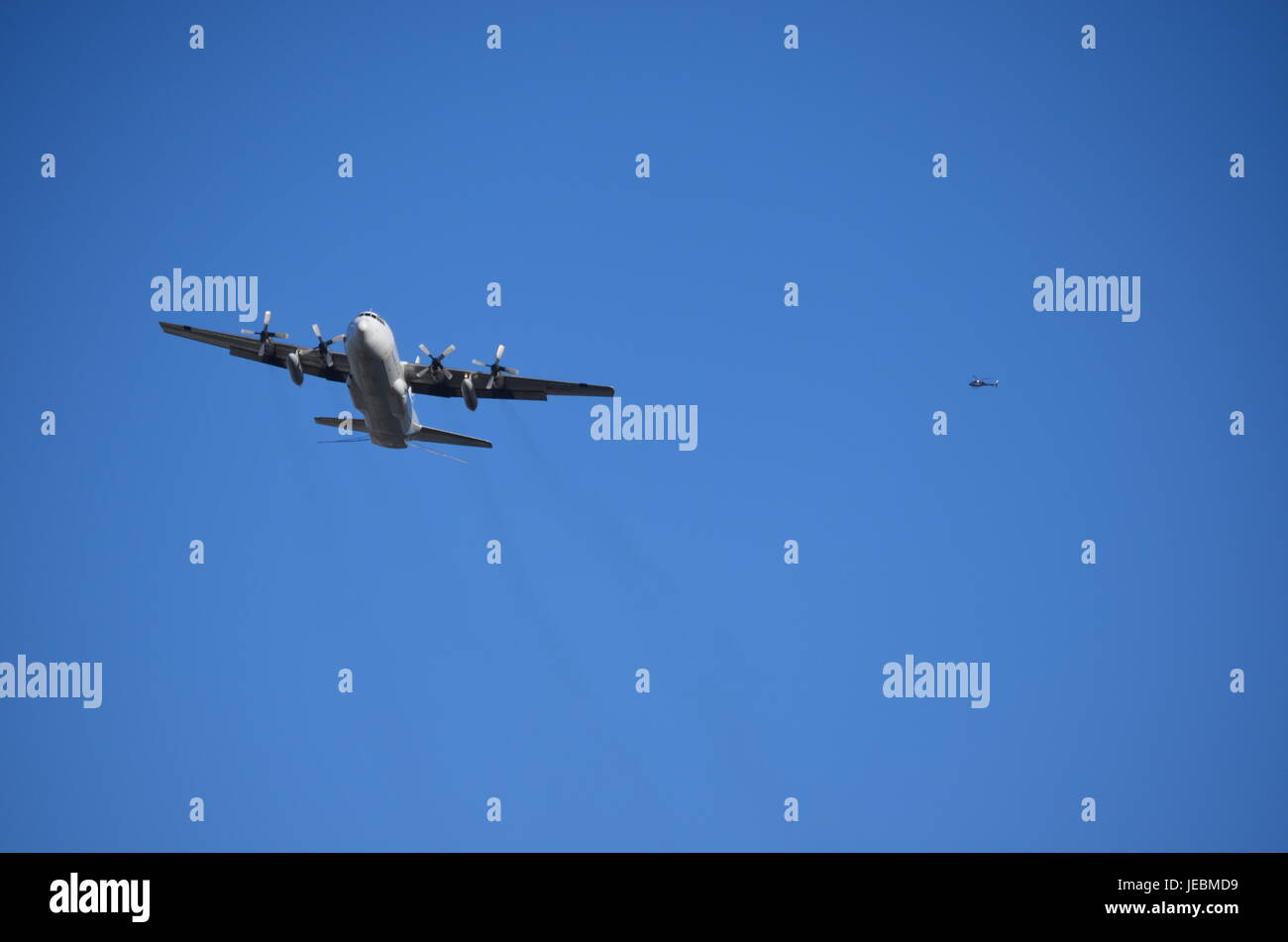 Military Four Helix Aircraft Flying with an Helicopter on the ...