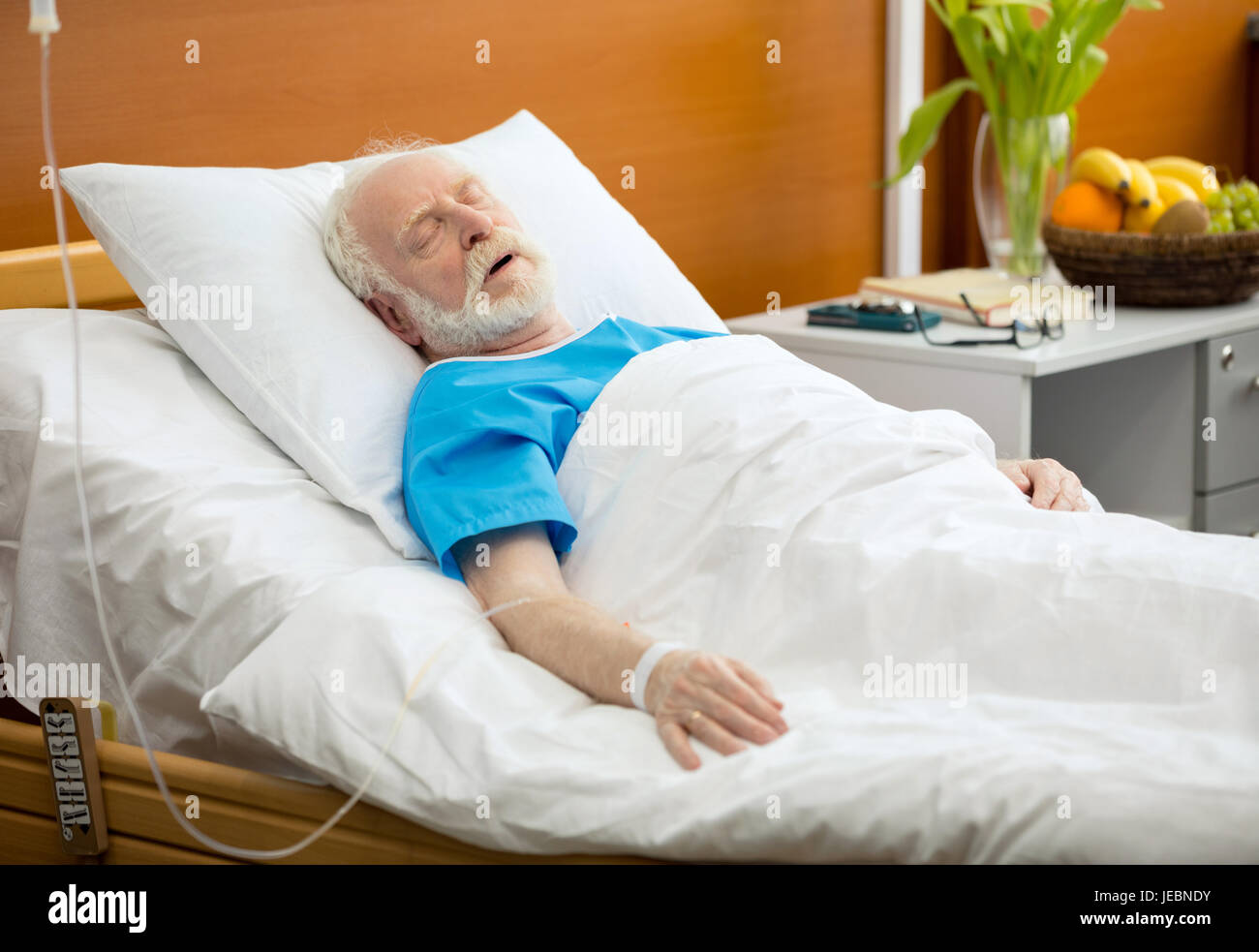 Bearded senior patient with closed eyes lying in hospital bed Stock ...