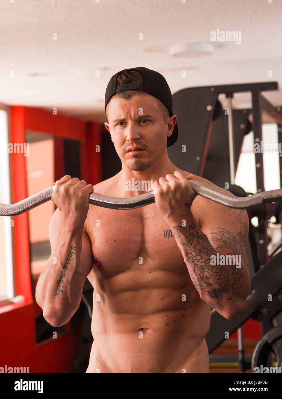 Muscular young man Performing Barbell Squats,one Of The Best ...
