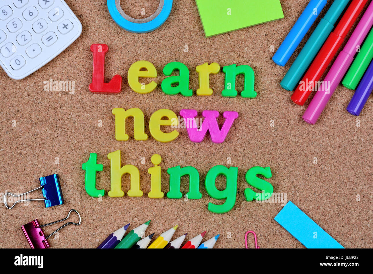 The words Learn new things on cork background Stock Photo - Alamy