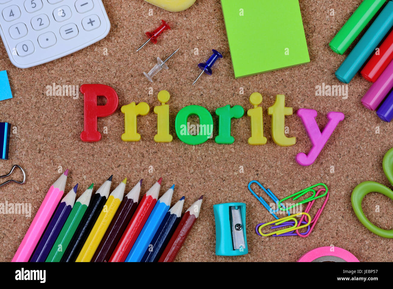 Priority word on cork background Stock Photo - Alamy