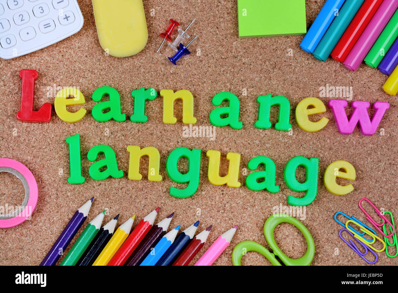 Learn a new language words on cork background Stock Photo - Alamy