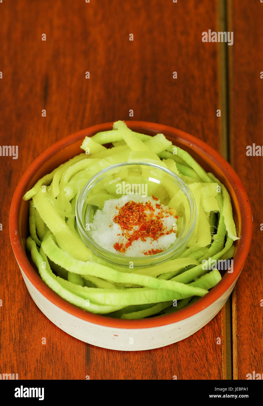 Close up shot of small sliced mango served with salt and chilli powder ...