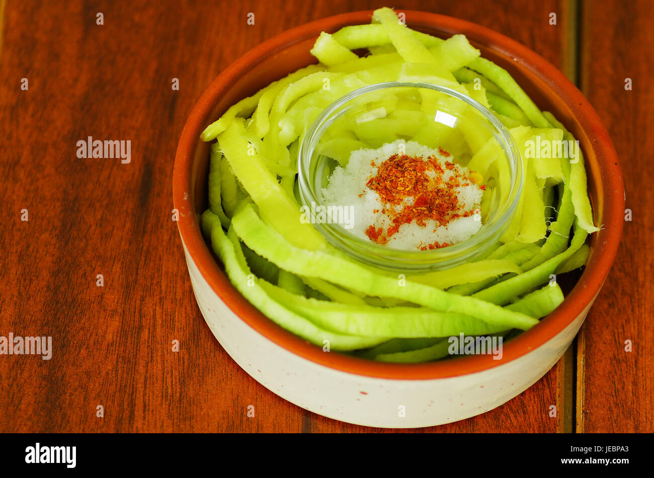 Close up shot of small sliced mango served with salt and chilli powder ...