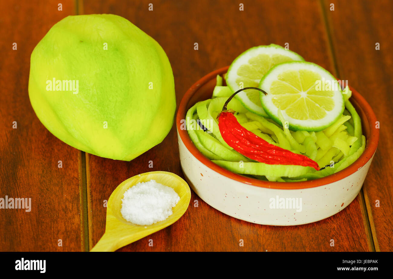 Close up shot of small sliced mango served with salt and a red chilli ...