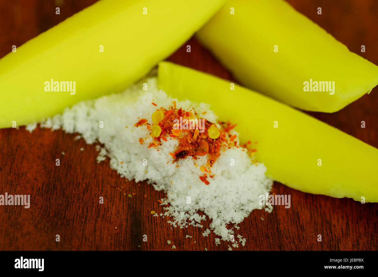 Close up shot of fresh sliced mango served with salt and chilli powder ...