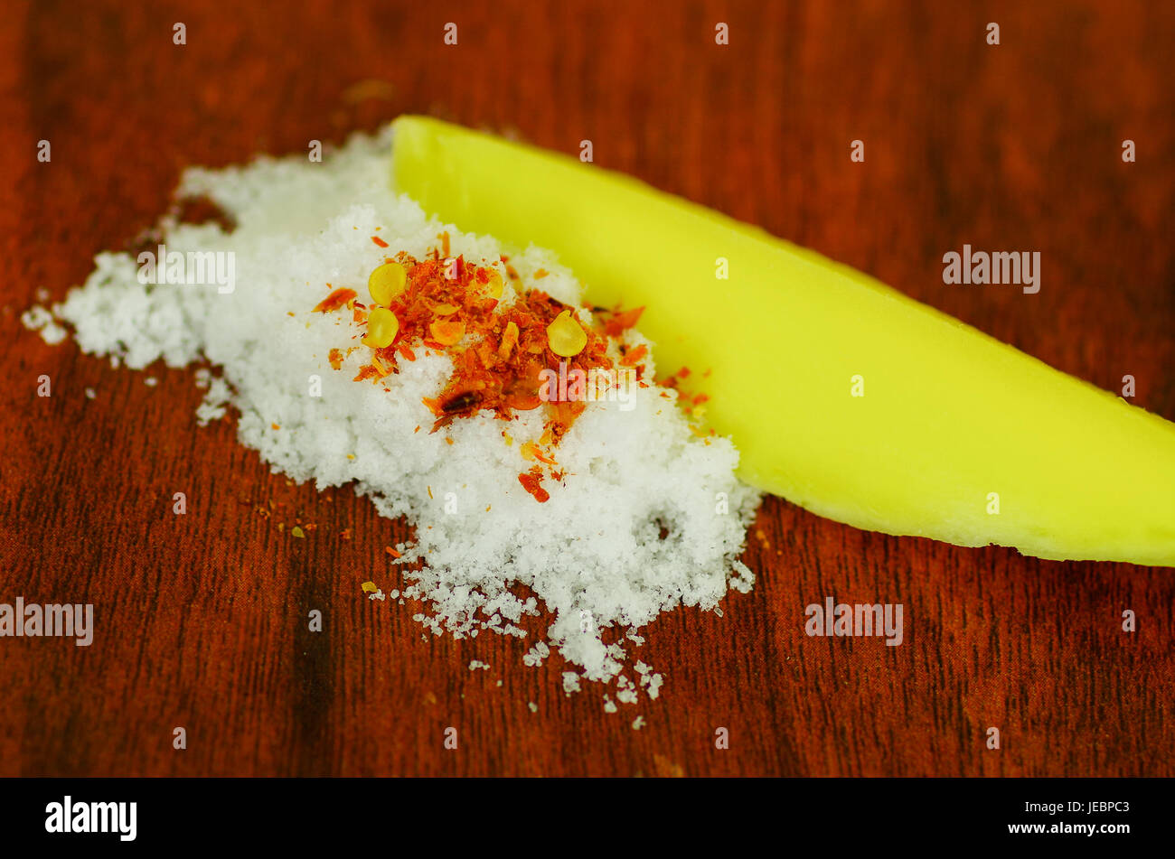 Close up shot of fresh sliced mango served with salt and chilli powder ...