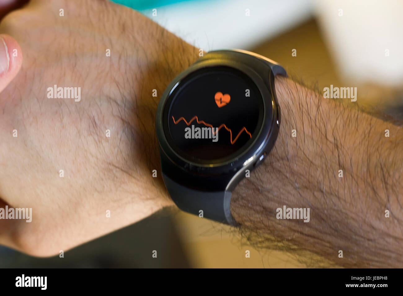 Man measuring heart beat in smartwatch Stock Photo - Alamy