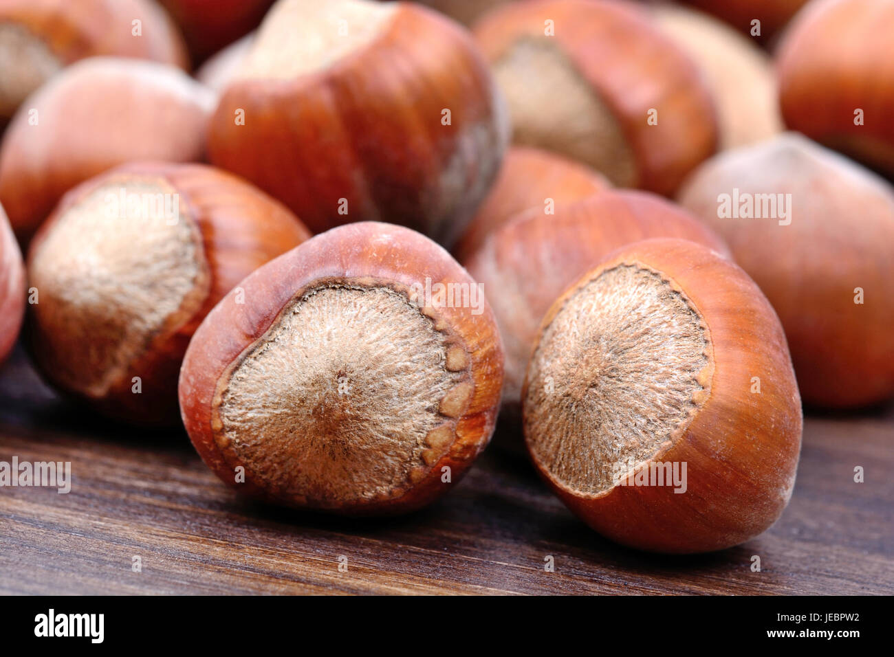 Heap of hazelnuts on wooden table Stock Photo - Alamy