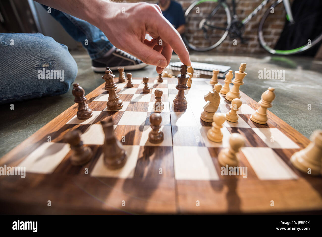 young men sitting on floor and playing chess on chess board Stock Photo ...