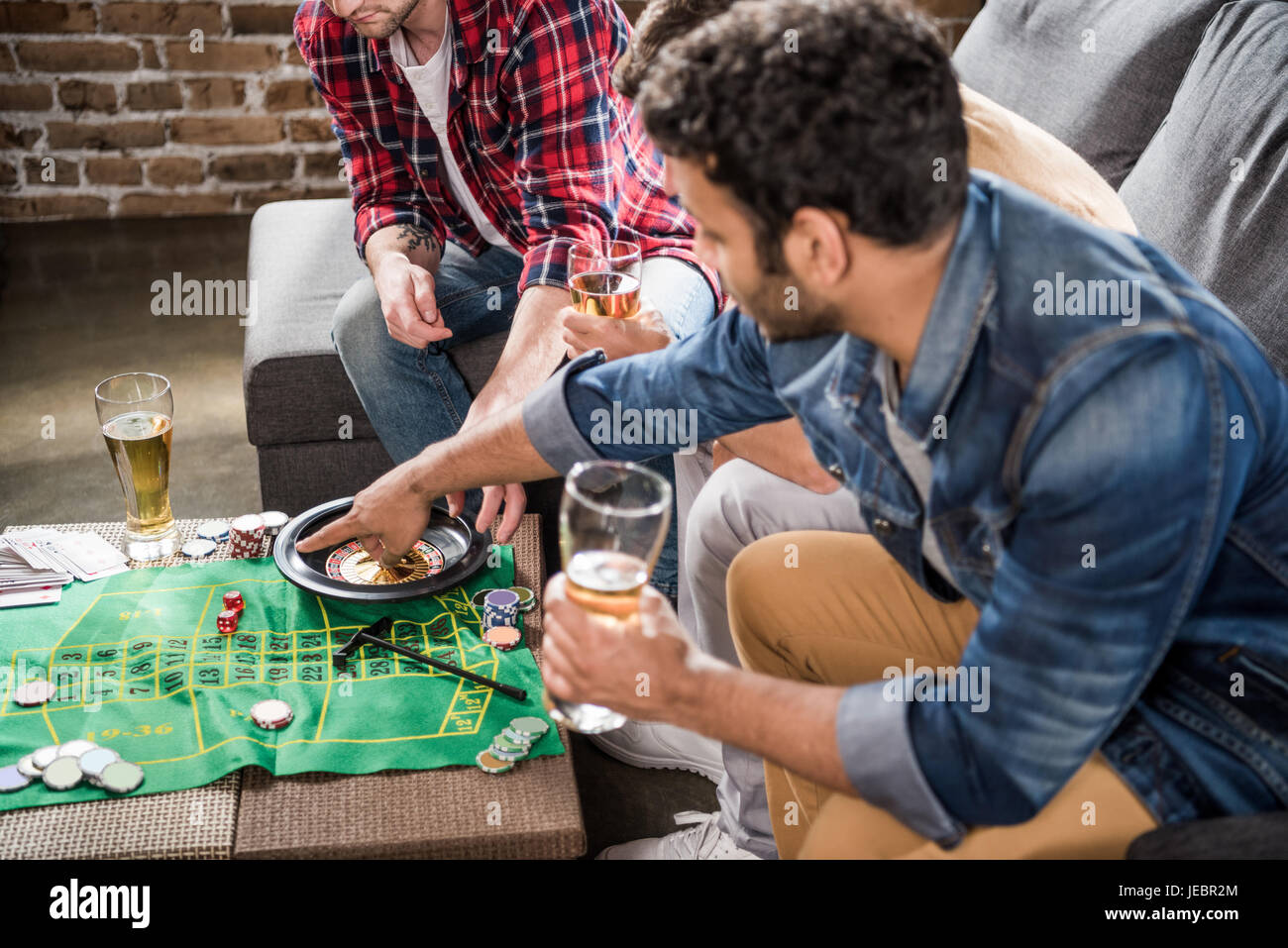 young men playing roulette game. young people having fun concept Stock ...