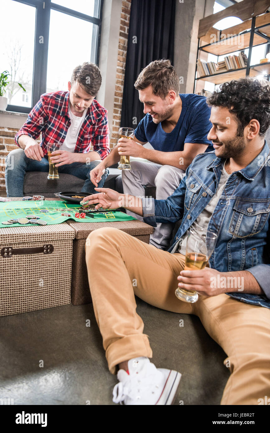 young men playing roulette game. young people having fun concept Stock ...