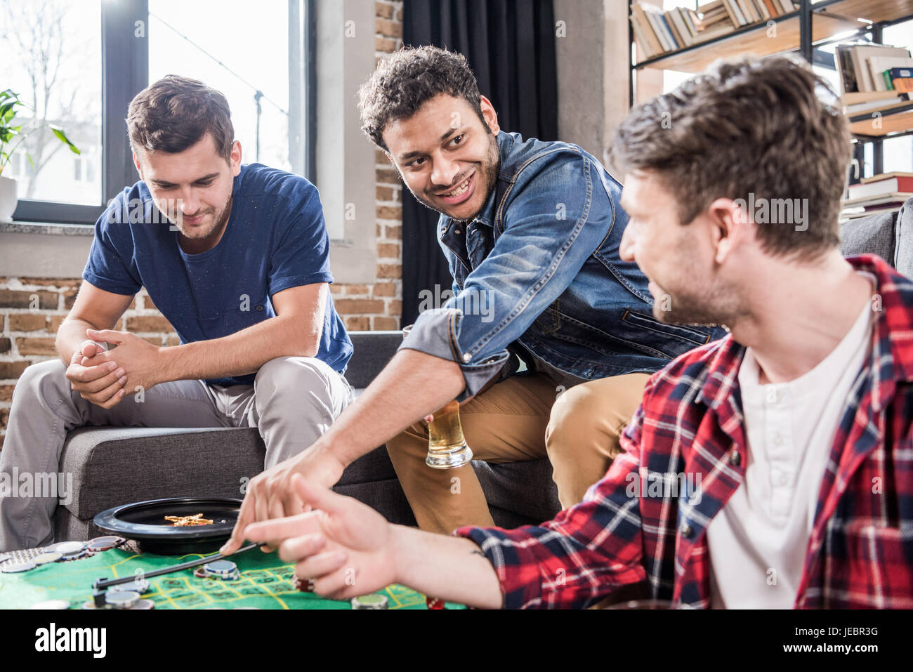 young men playing roulette game. young people having fun concept Stock ...