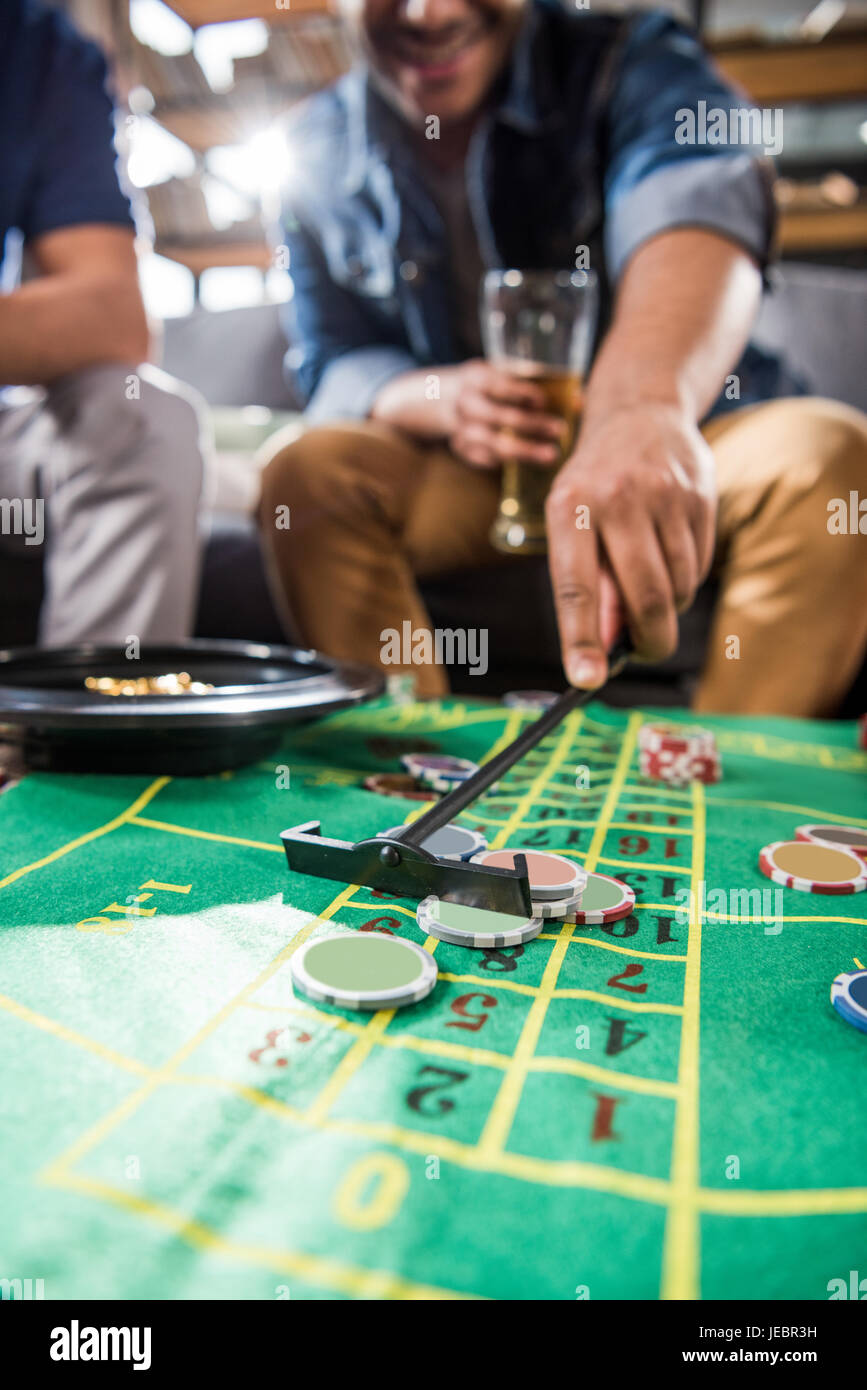 young men playing roulette game. young people having fun concept Stock ...