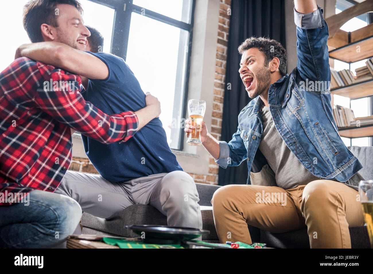 excited young men playing roulette game. young people having fun ...