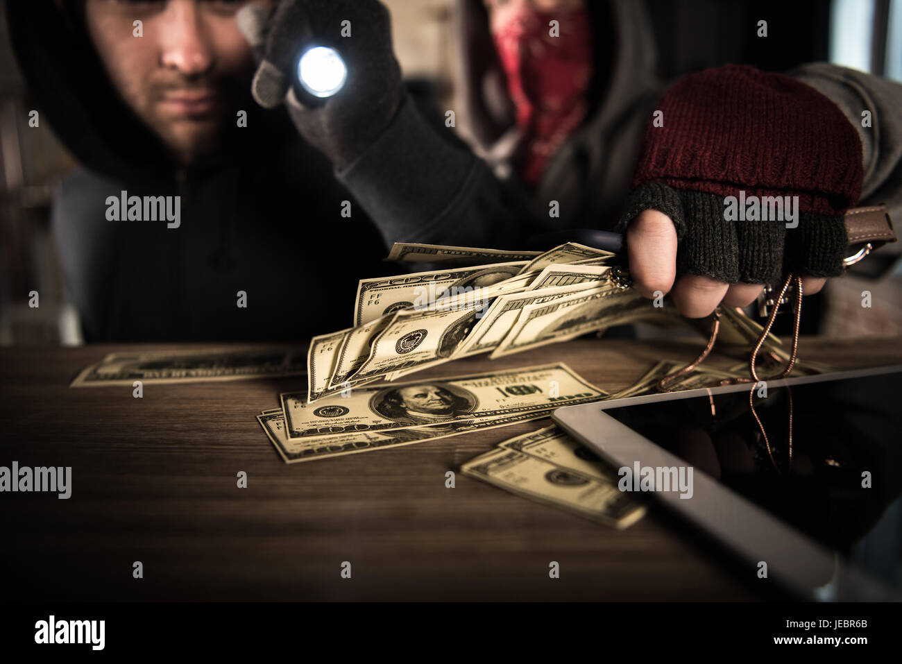Close-up view of burglars stealing valuables from shelf, house robbery ...