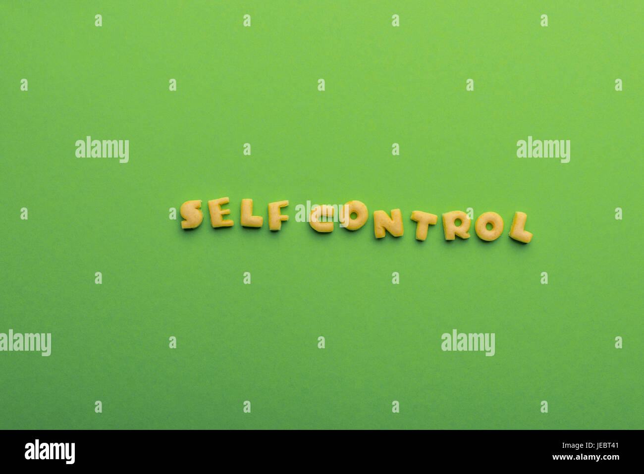 self controt concept, words made of cookies isolated on green. healthy ...