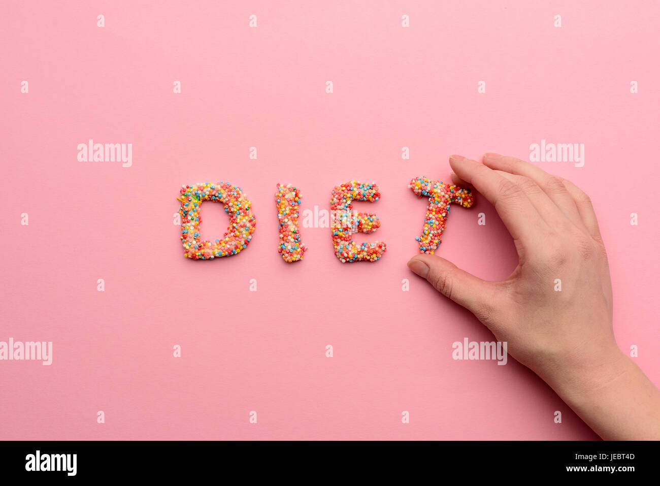 Close-up view of word diet made from sweets and human hand holding ...