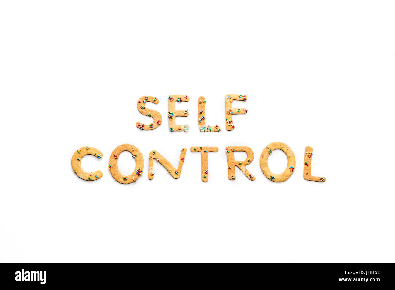 Top view of self control lettering made from sweets isolated on white ...
