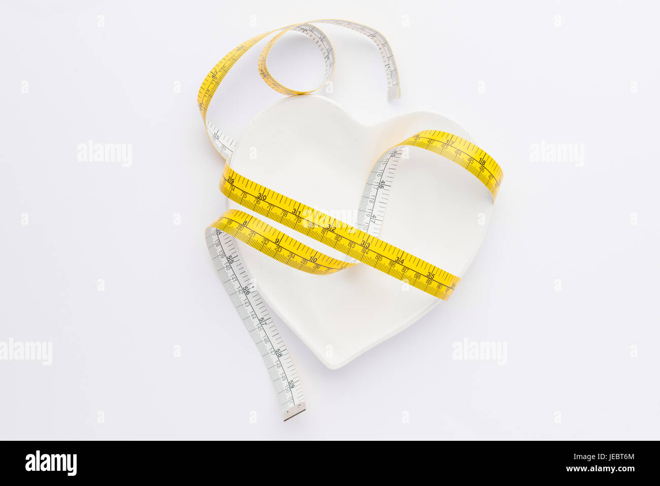 measuring tape wrapped around plate isolated on white, healthy living ...