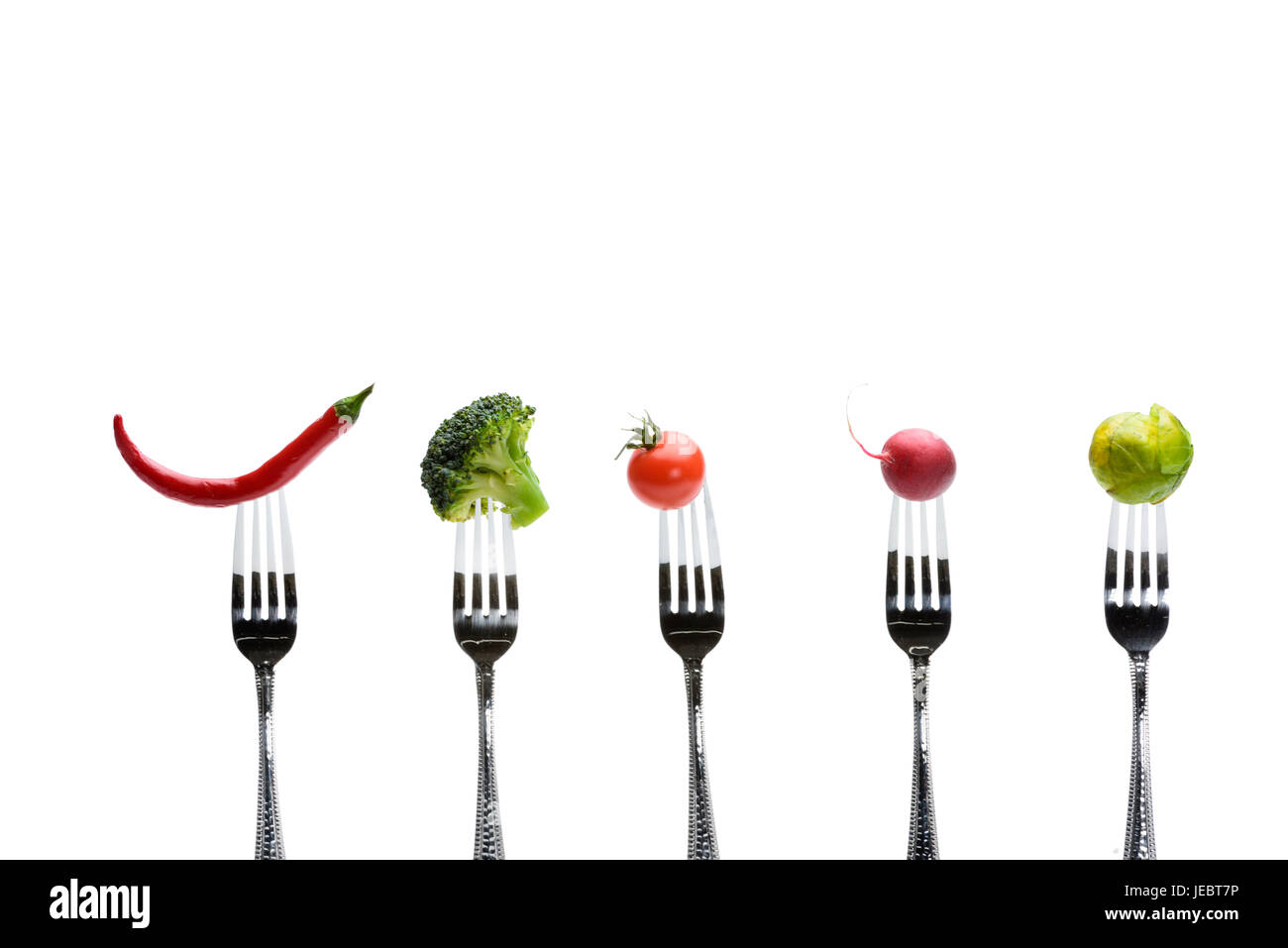fresh vegetables on forks isolated on white, healthy living concept ...
