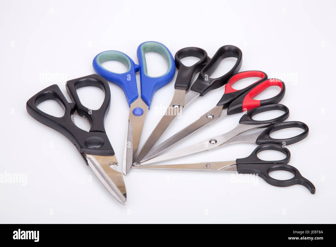 Bunch of scissors of different style and size on a white surface ...