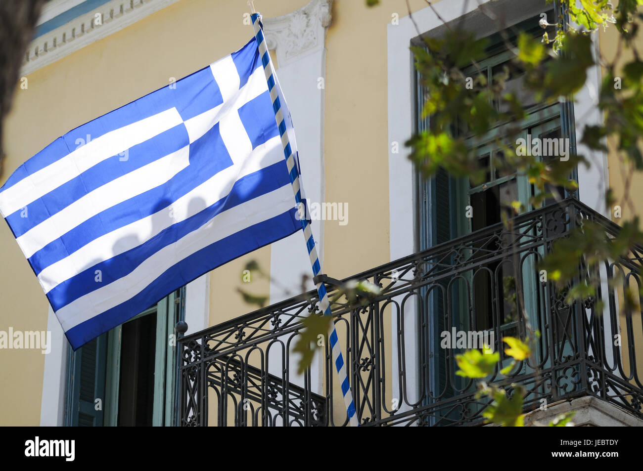 A greek flag waves on a building facade in Athens, Greece Stock Photo ...