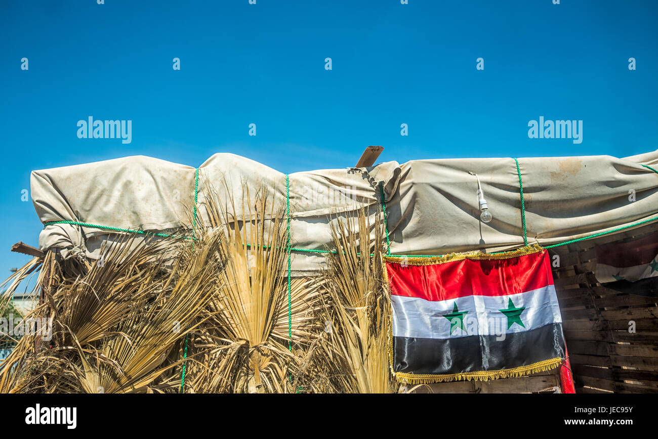 Guard shack with Syrian Army flag at a checkpoint on the Syrian border ...
