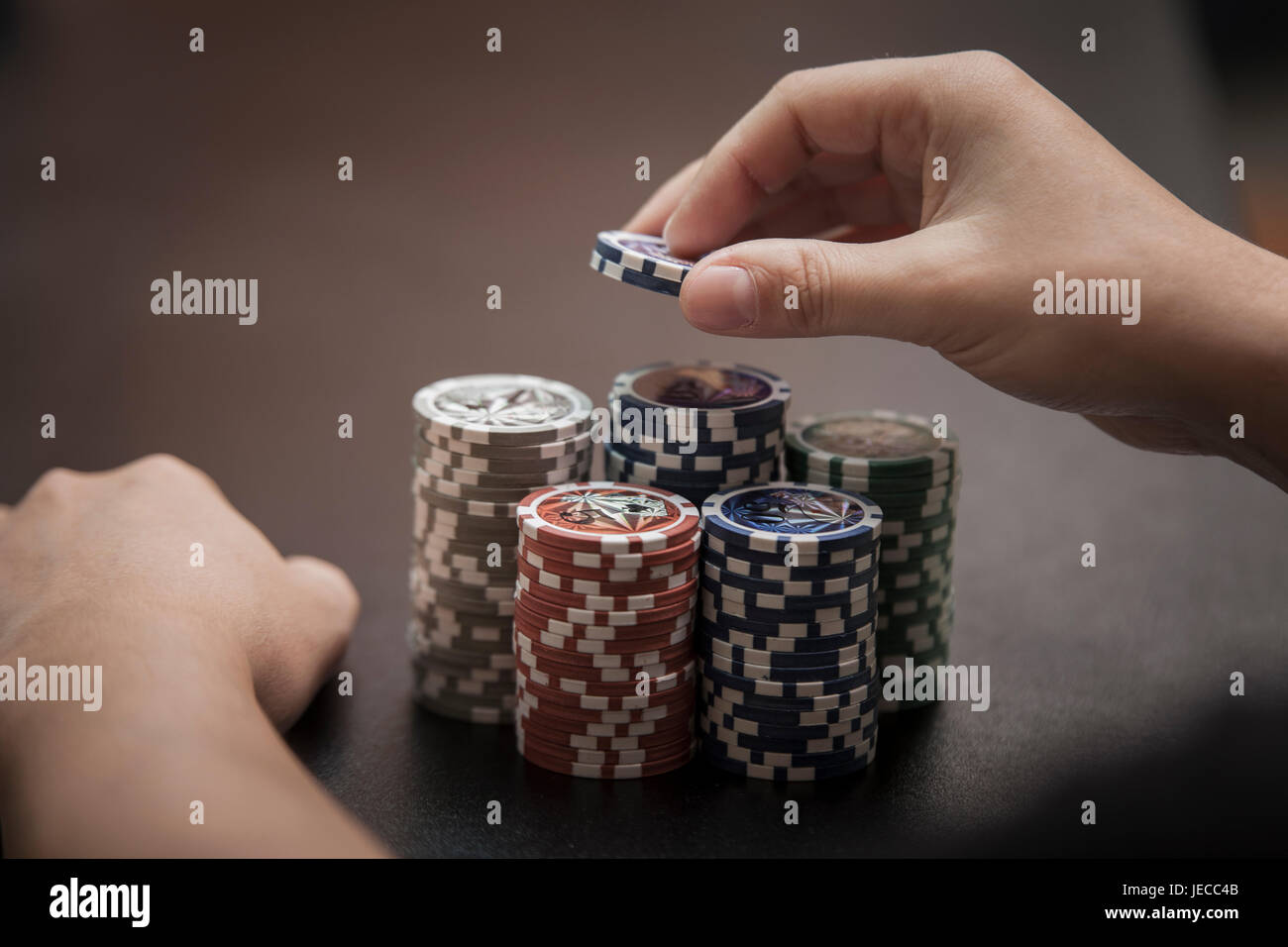 Man's hands pull to themselves a big heap of poker chips Stock Photo ...