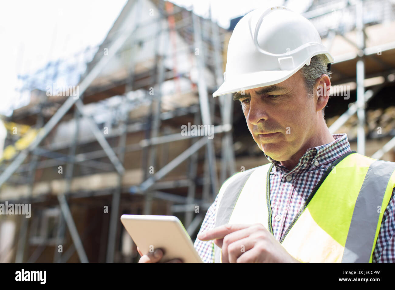 Architect On Building Site Using Digital Tablet Stock Photo - Alamy
