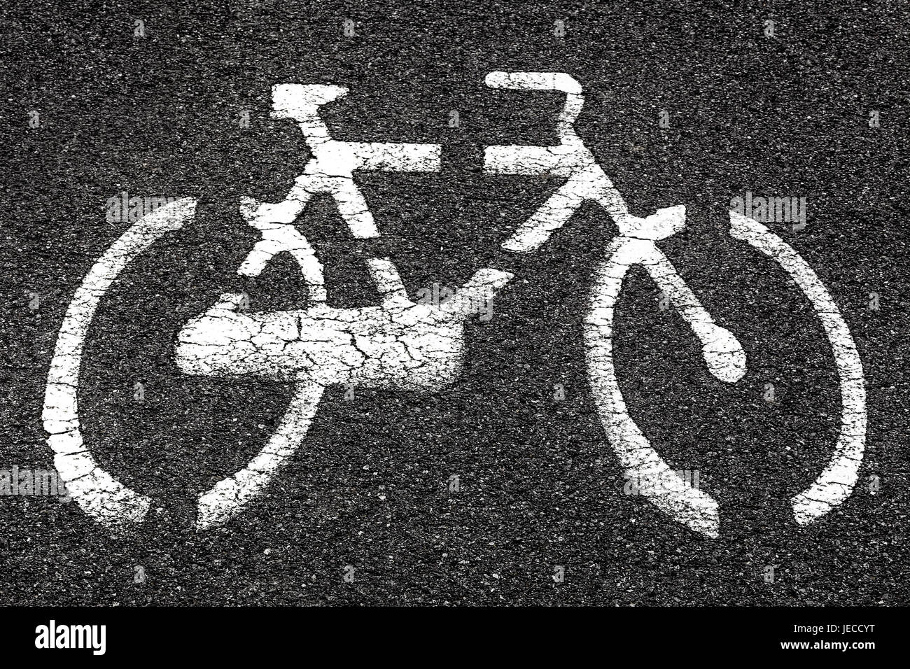 Bicycle sign on black asphalt pavement Stock Photo - Alamy
