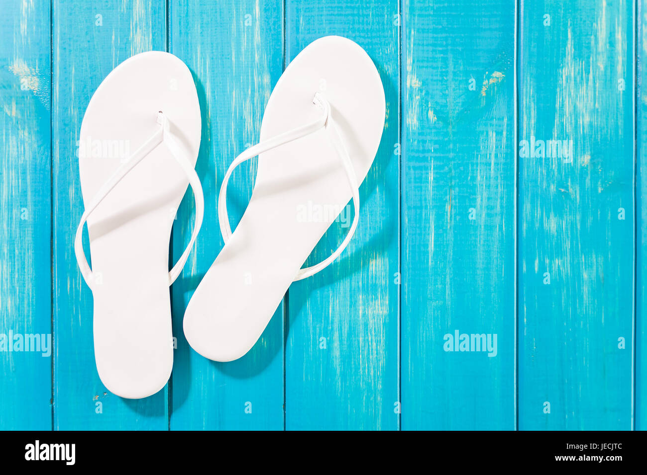 White women's flip flops on a wood board Stock Photo - Alamy