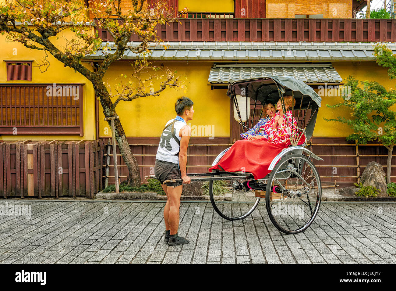 KYOTO, JAPAN: Customers took a ride on a rickshaw and arrived at their ...