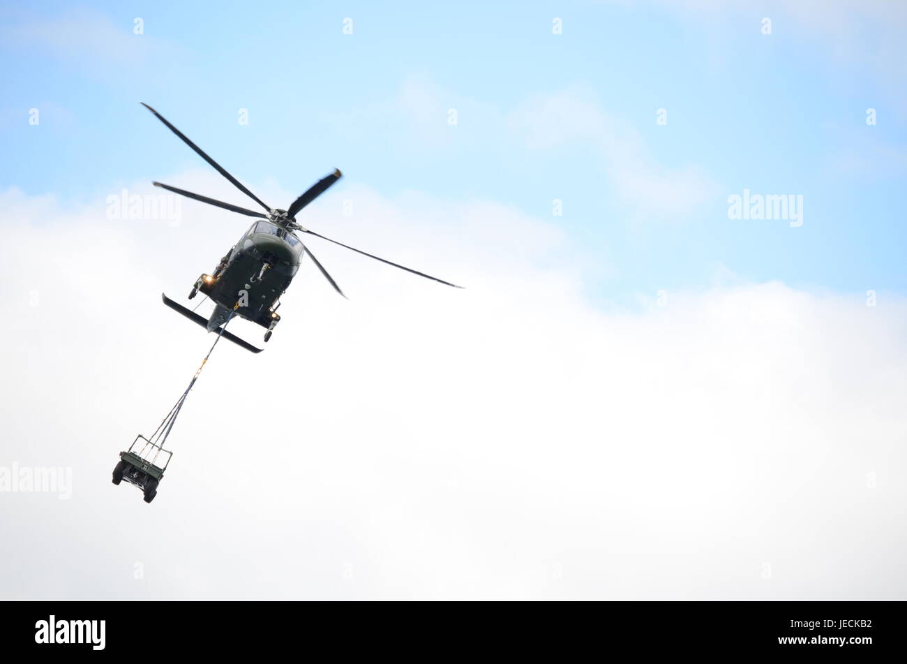 Green Military Helicopter Carrying a Jeep Stock Photo - Alamy