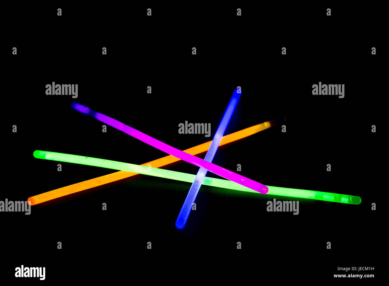 Glow sticks neon light fluorescent on back background. variation of ...