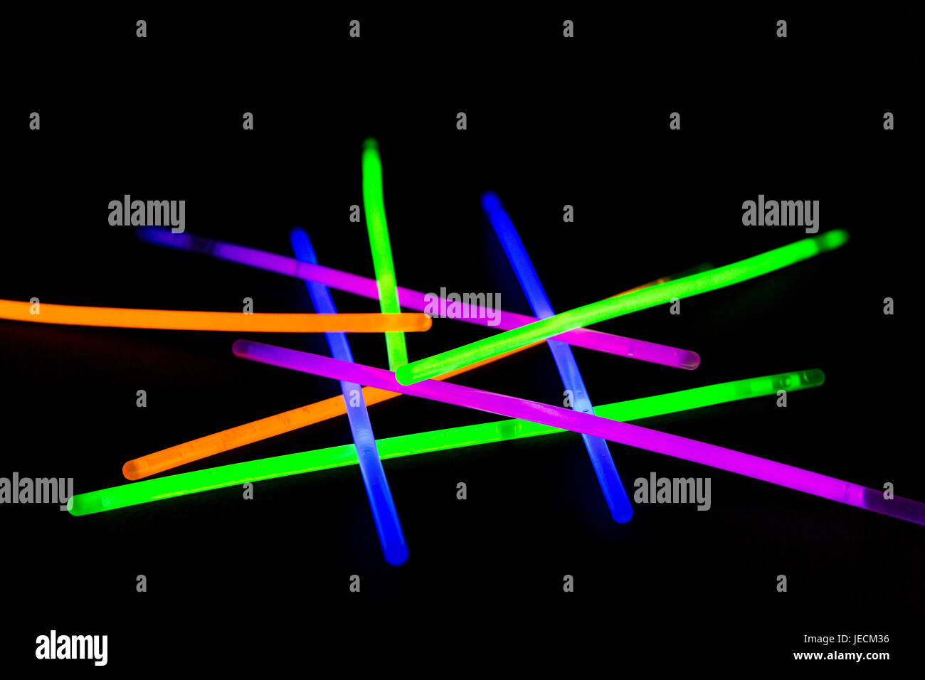 Glow sticks neon light fluorescent on back background. variation of ...