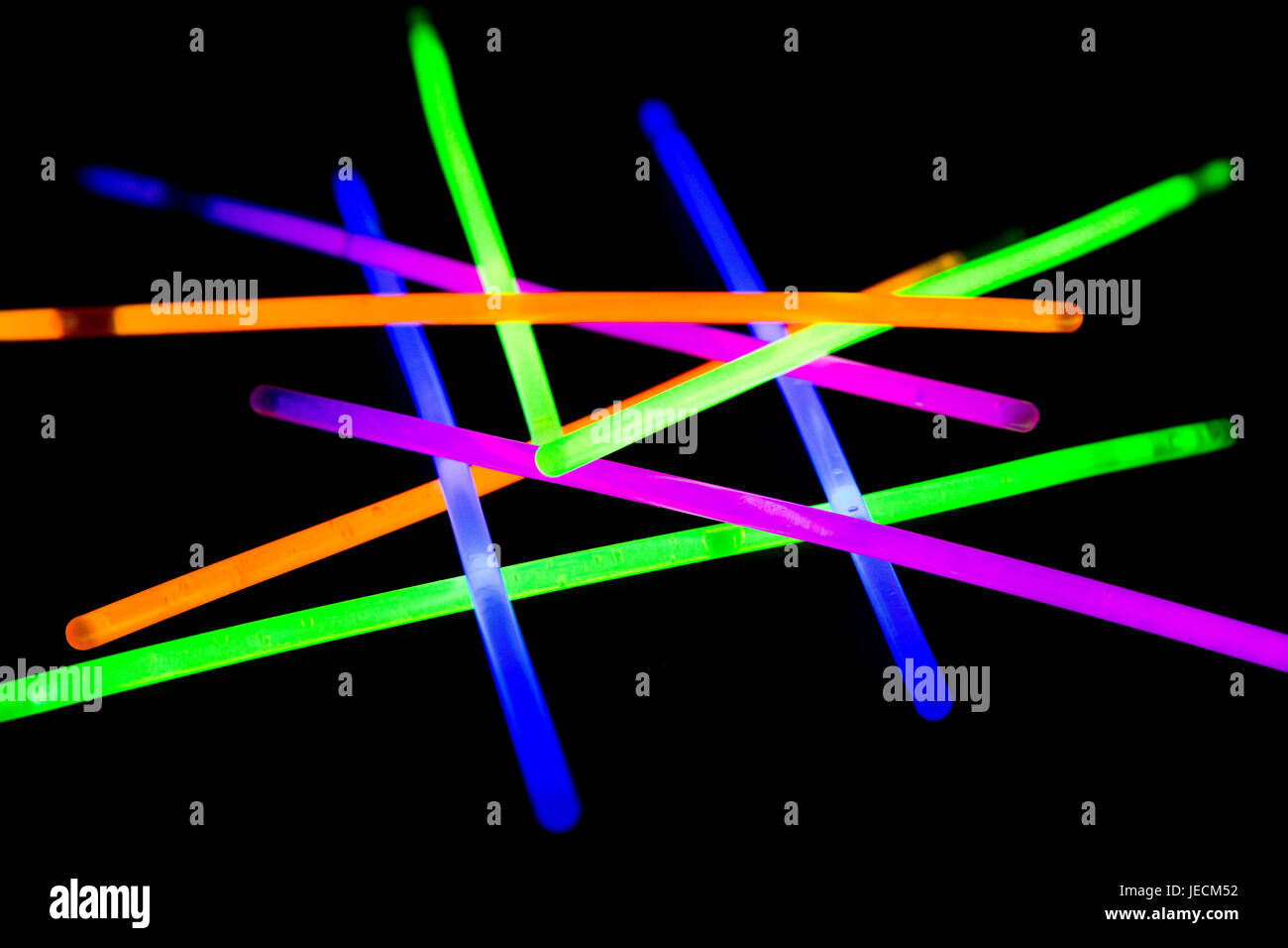 Glow sticks neon light fluorescent on back background. variation of ...